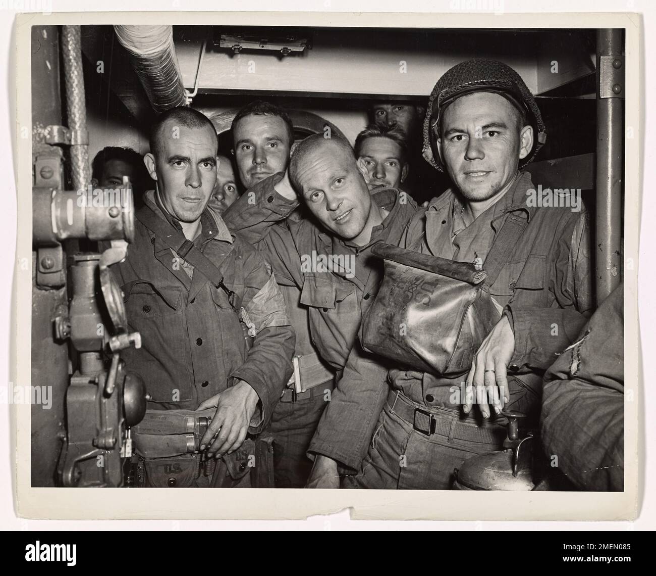 This image shows Army men packed into a troop compartment aboard a ...