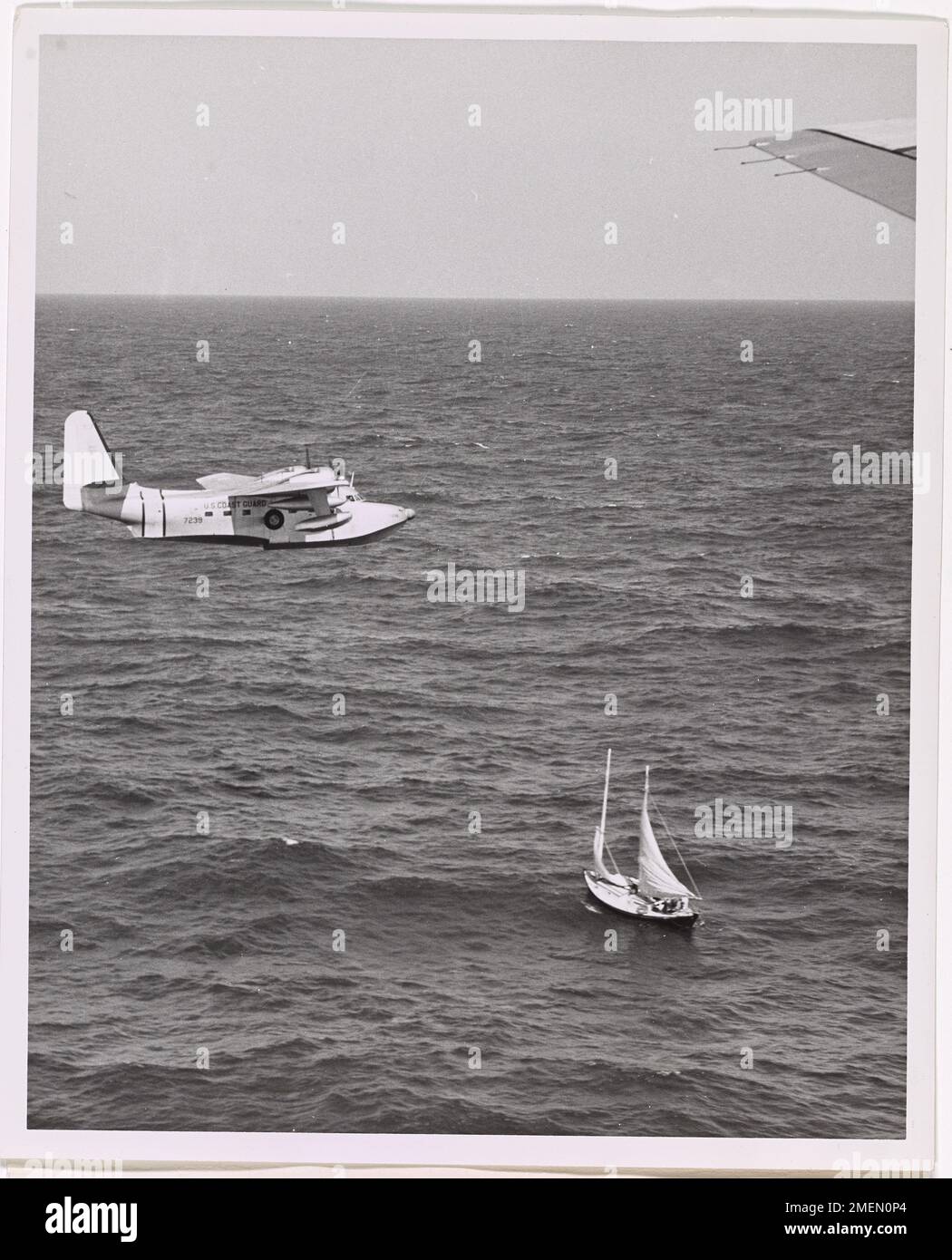 A Coast Guard plane provides assistance to the sailboat Gina. This ...