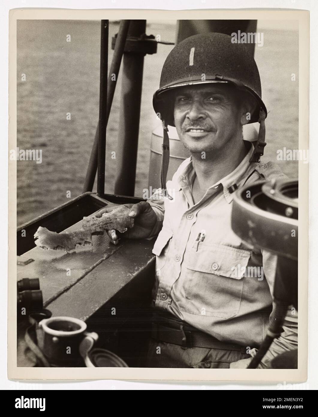 Lieutenant Benjamin Ayesa of the U.S. Coast Guard holds a piece of ...