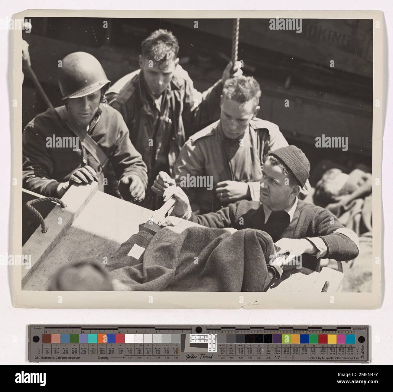 Easy Does It. Crew members of a Coast Guard assault transport transfer ...