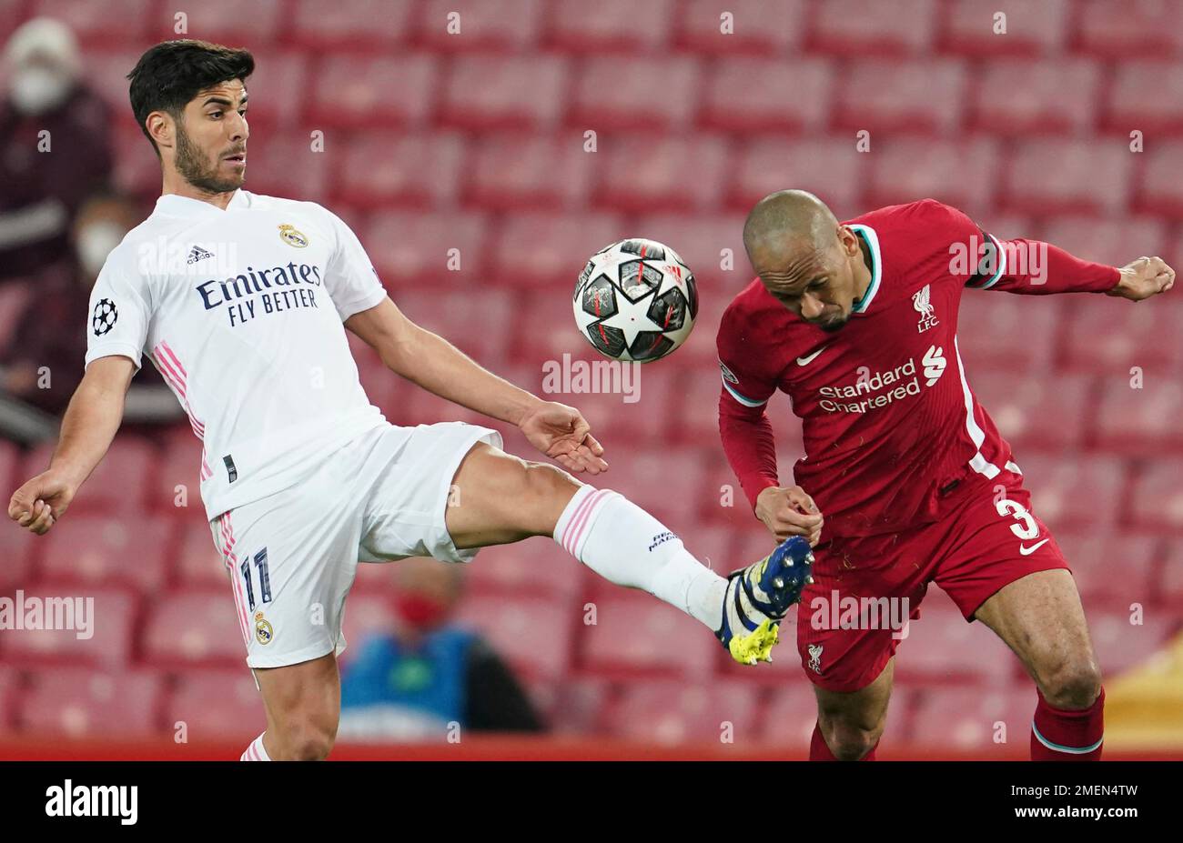 Real Madrid's Marco Asensio, left, fights for the ball with Liverpool's ...