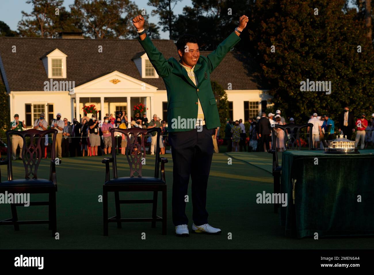 Hideki Matsuyama, of Japan, raises his arms after winning the Masters ...