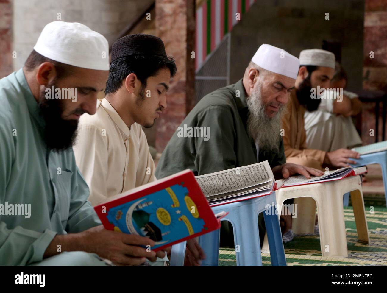 Muslims read passages from the Quran, the Muslim holy book, during the ...