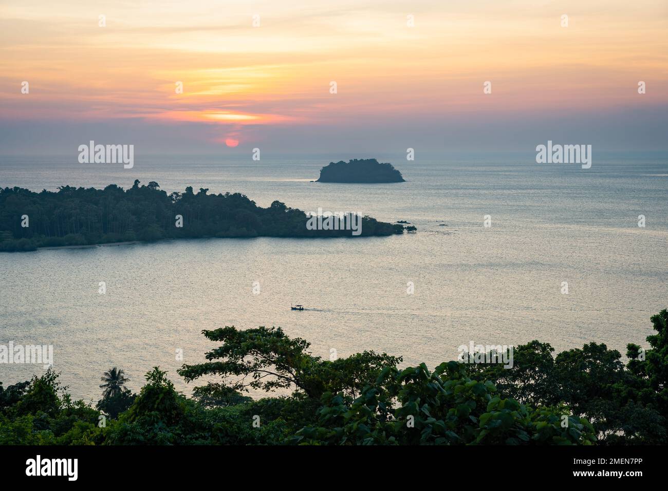 The view over the calm waters of the sea wit the pink sunset in the ...