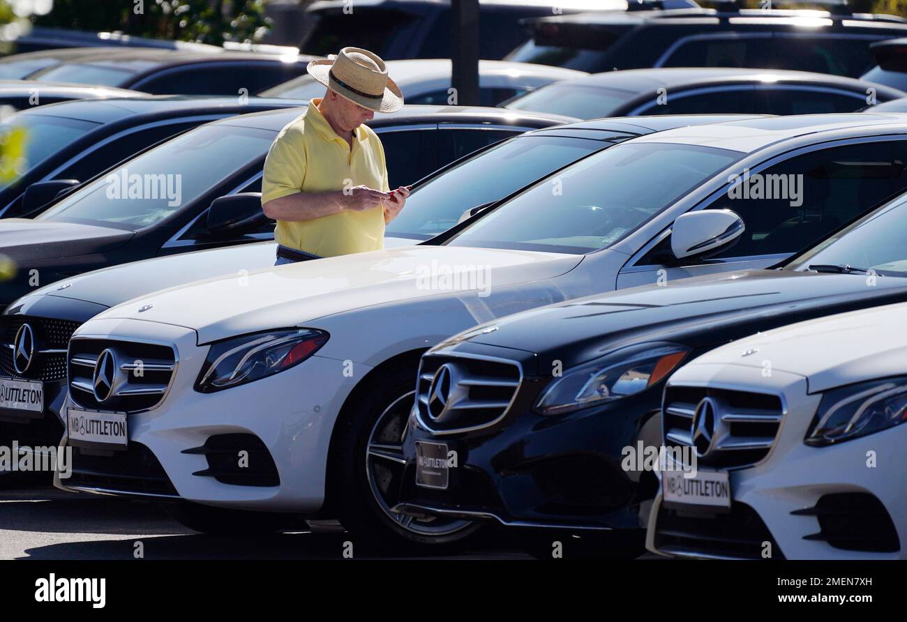 A shopper looks over a long line of 2020 sedans at a Mercedes Benz ...
