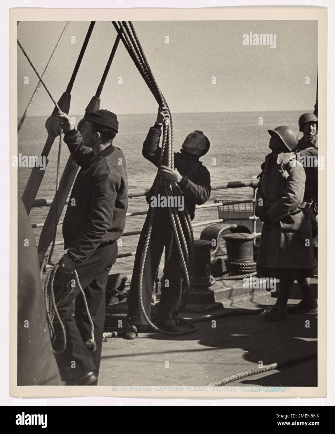 Coast Guardsmen participate in an Atlantic training exercise, lowering ...