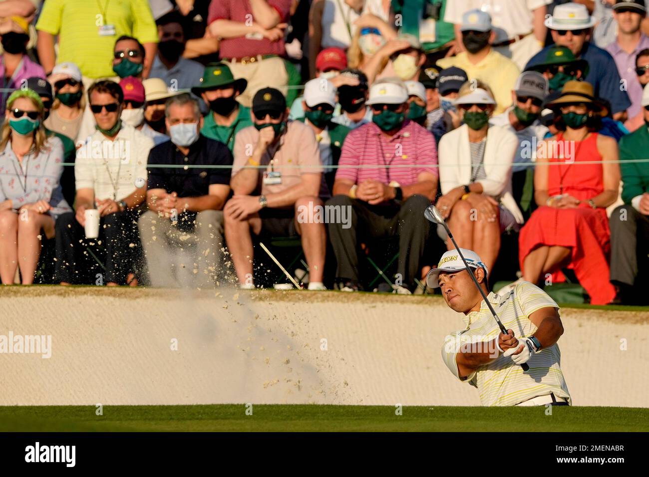 Hideki Matsuyama, of Japan, hits out of a bunker at the 18th green ...