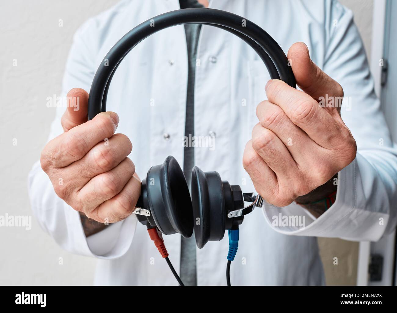 Audiometer headphones in hands of audiologist before audiometry test ...
