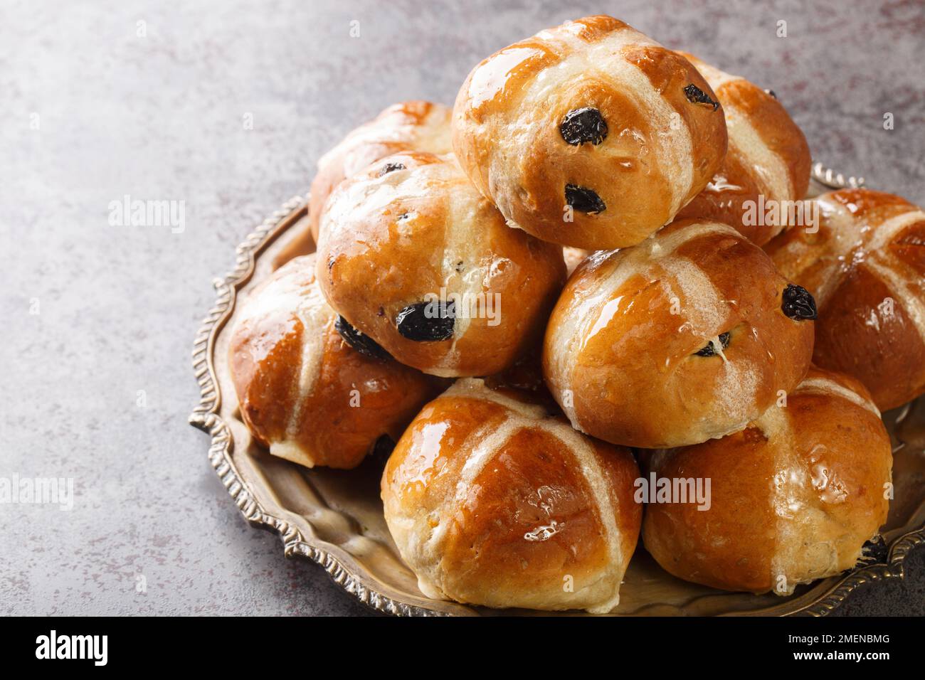 Hot cross bun is a spiced sweet bun made with raisins marked with a ...