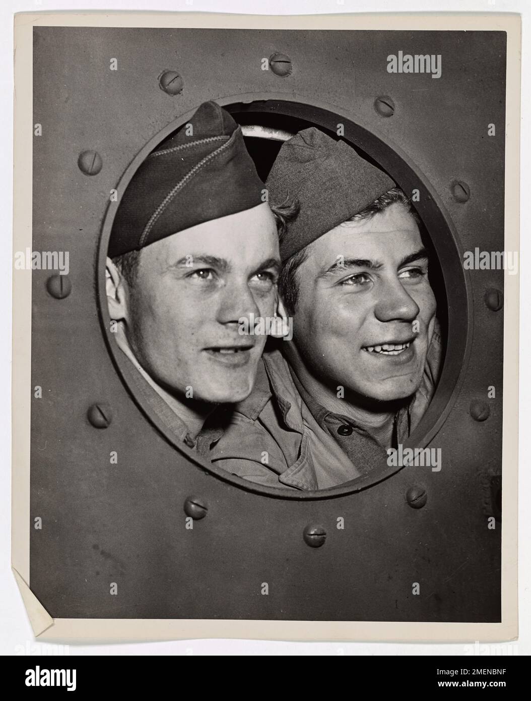 Soldiers aboard a Coast Guard-manned invasion transport look out the ...