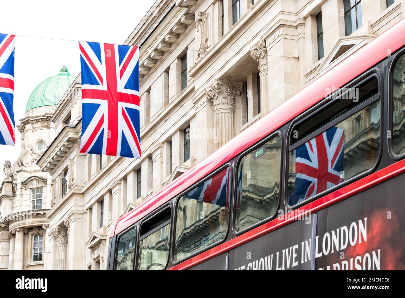 Union Jack flags reflected in the red London bus on Regent Street ...