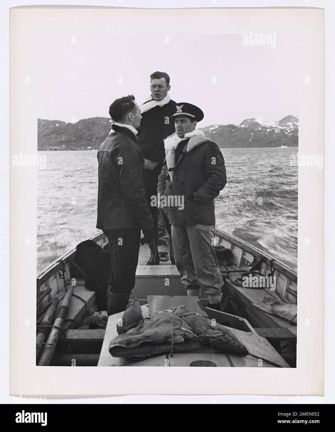 This image captures three Coast Guardsmen—T. R. Sargent, J. A. Cornish ...