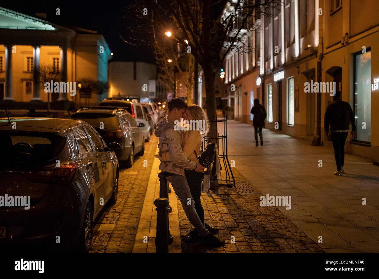 A couple hug as they stand on a warm spring evening in an empty Old ...