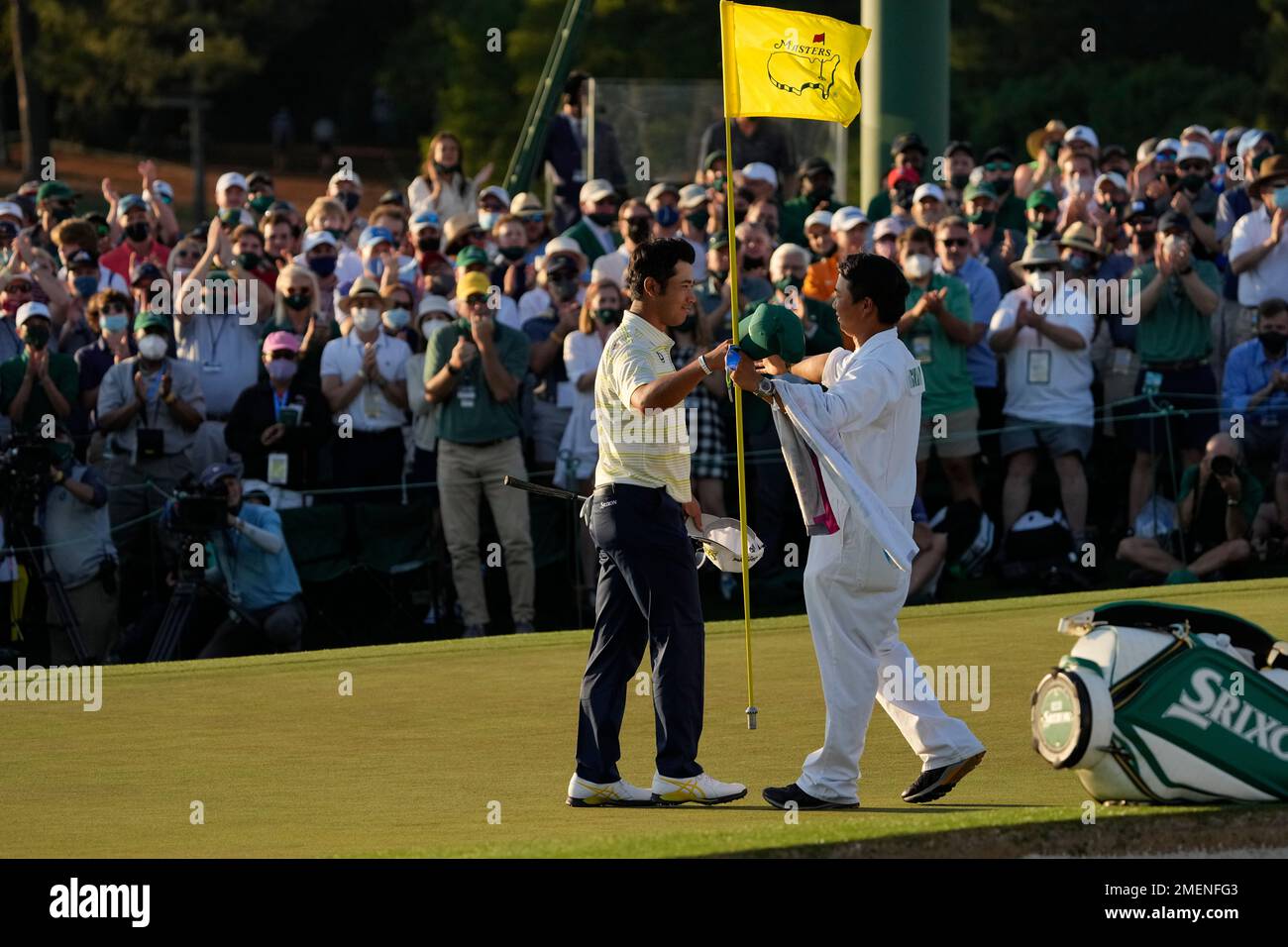 Hideki Matsuyama, of Japan, hugs his caddie Shota Hayafuji after ...