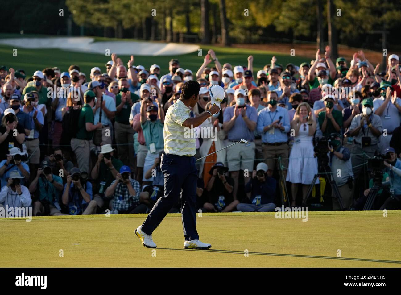 Hideki Matsuyama, of Japan, hugs his caddie Shota Hayafuji after ...