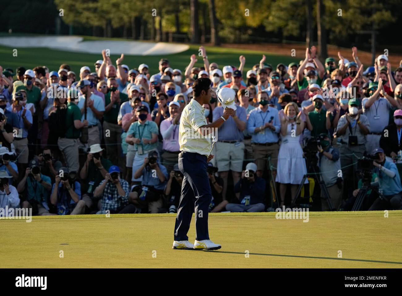 Hideki Matsuyama, of Japan, hugs his caddie Shota Hayafuji after ...