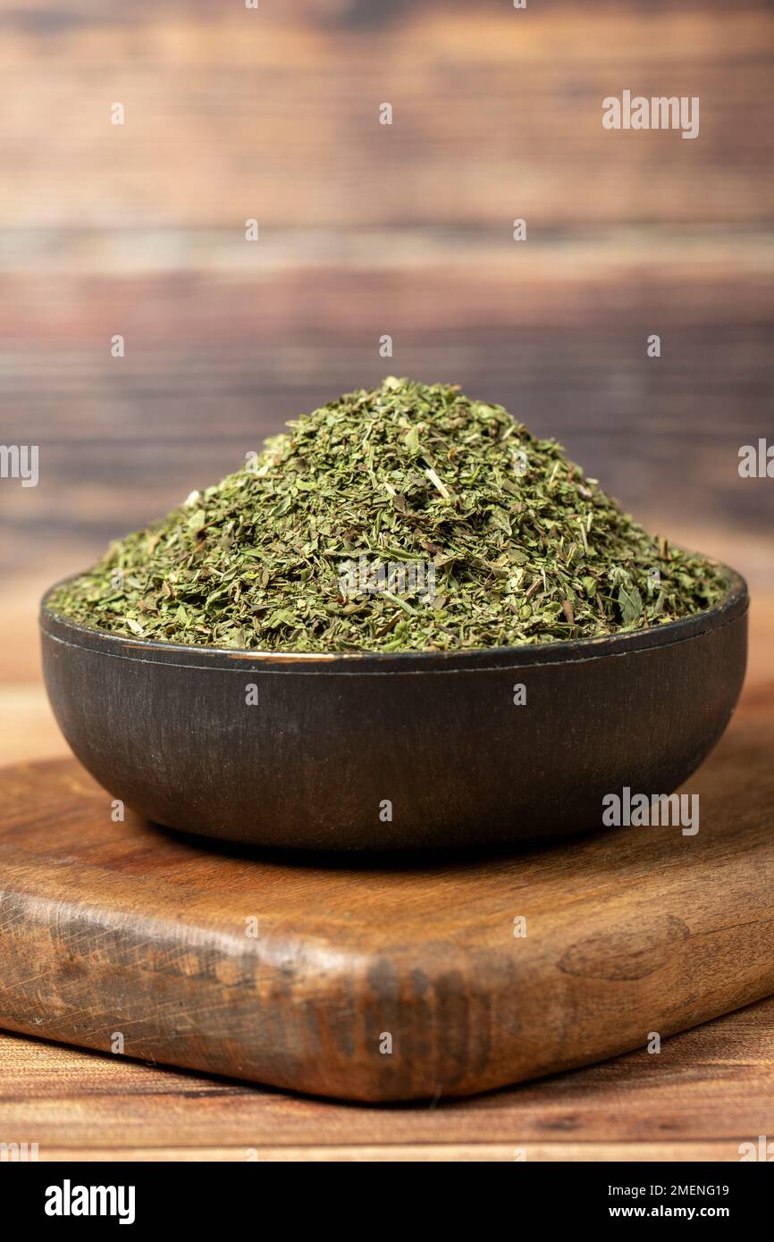 Dried mint spice. Dried mint leaves in bowl on rustic table. Dry spice ...