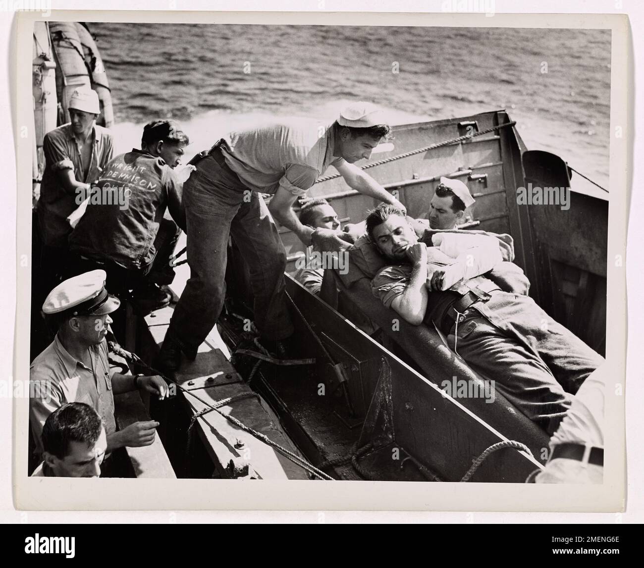 Wounded American soldiers are transferred from a landing barge to a ...