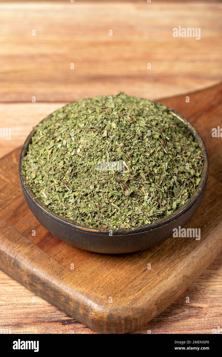 Dried mint spice. Dried mint leaves in bowl on rustic table. Dry spice ...
