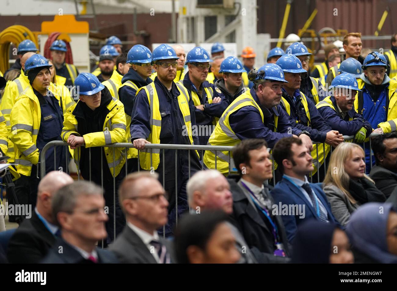 Workers look on as the first cut of steel for the Royal Navy frigate ...