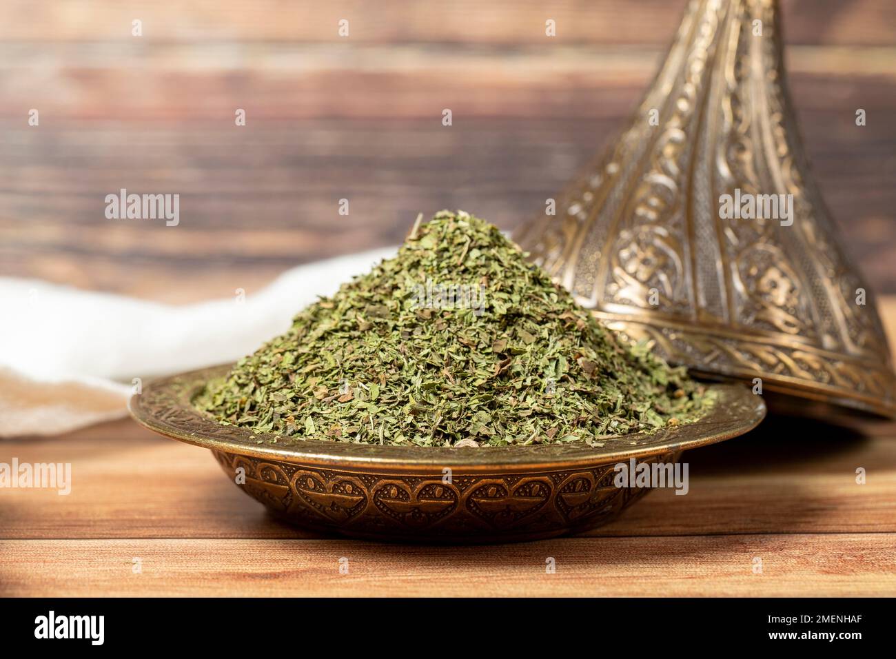 Dried mint spice. Dried mint leaves in bowl on rustic table. Dry spice ...