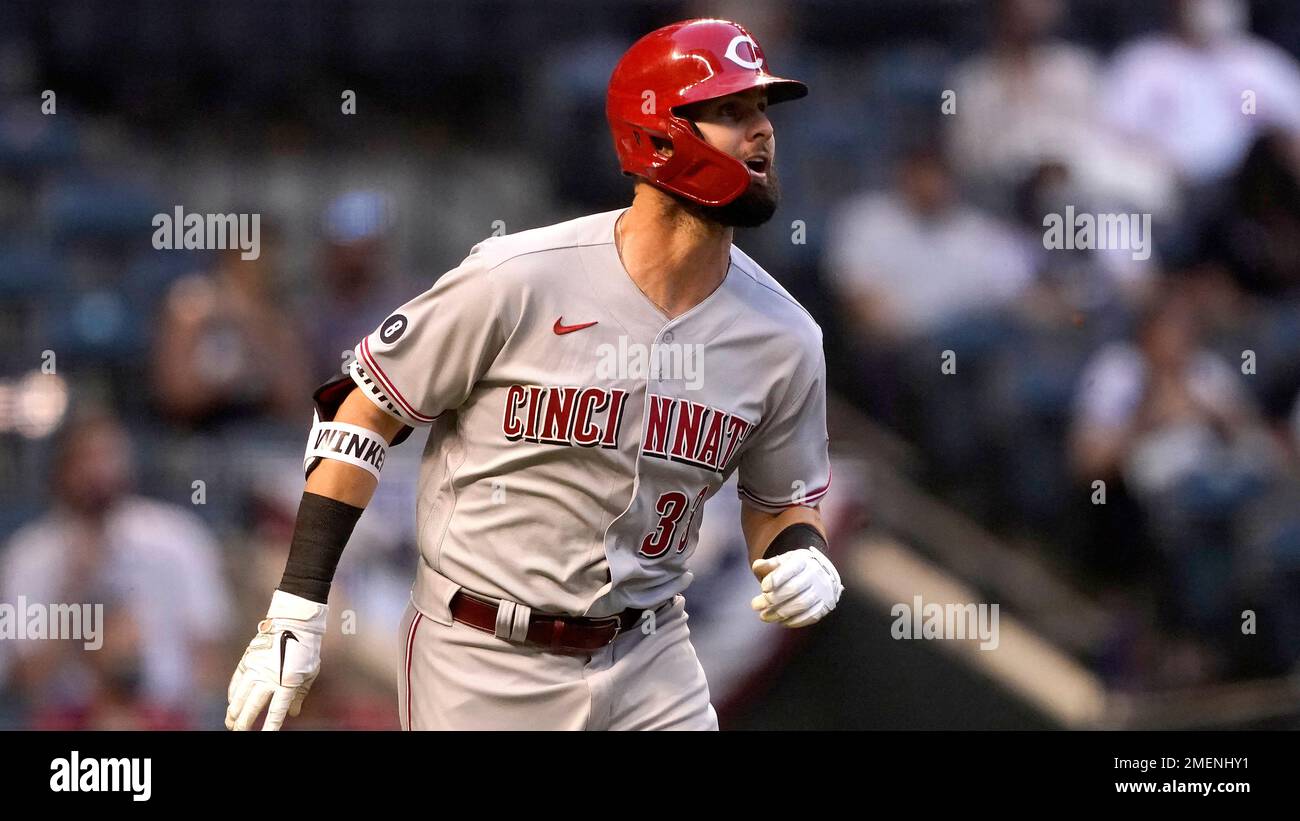 Cincinnati Reds' Jesse Winker watches his double bounce off the ...