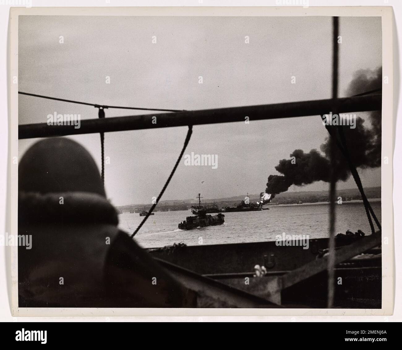 A Coast Guard crewman observes the explosion of a gasoline barge after ...