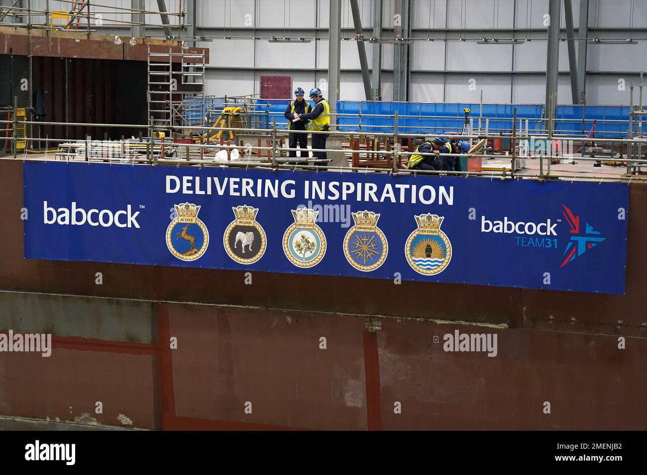 Workers work on HMS Ventura in the Ventura building after a ceremony ...