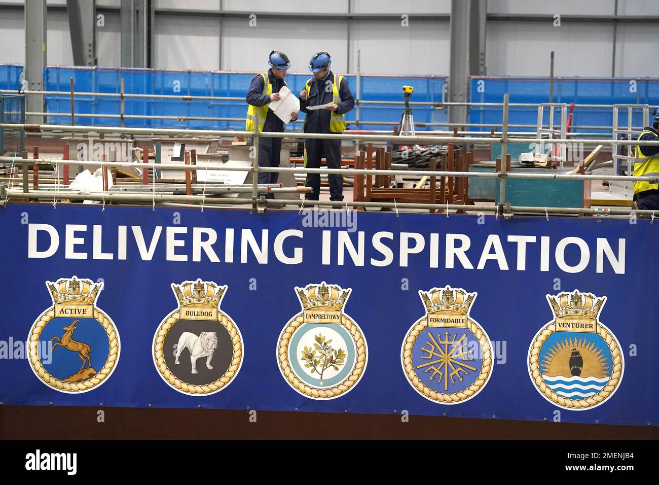 Workers work on HMS Ventura in the Ventura building after a ceremony ...