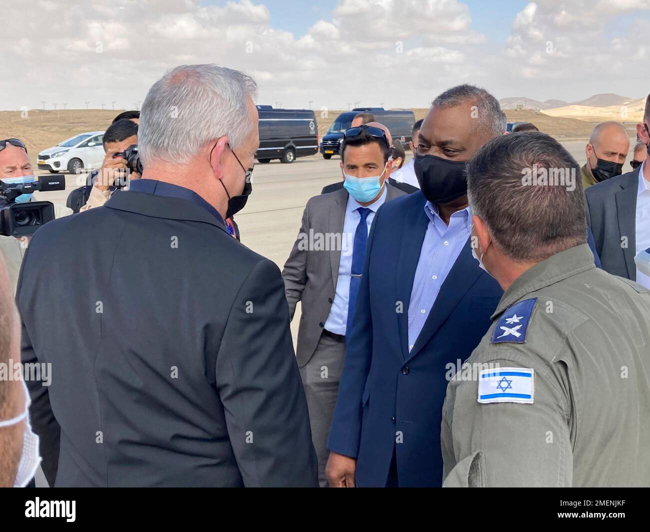 Defense Secretary Lloyd Austin, second from right, is greeted by ...