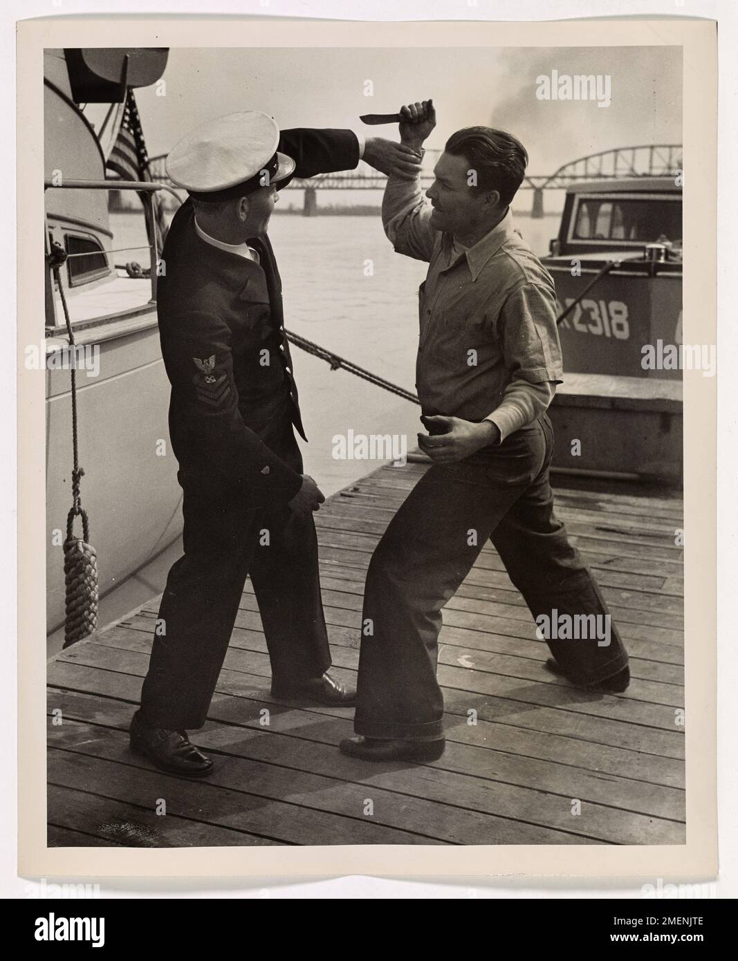 Warding off a frontal knife attack, Chief Kessler stops Rollston's ...