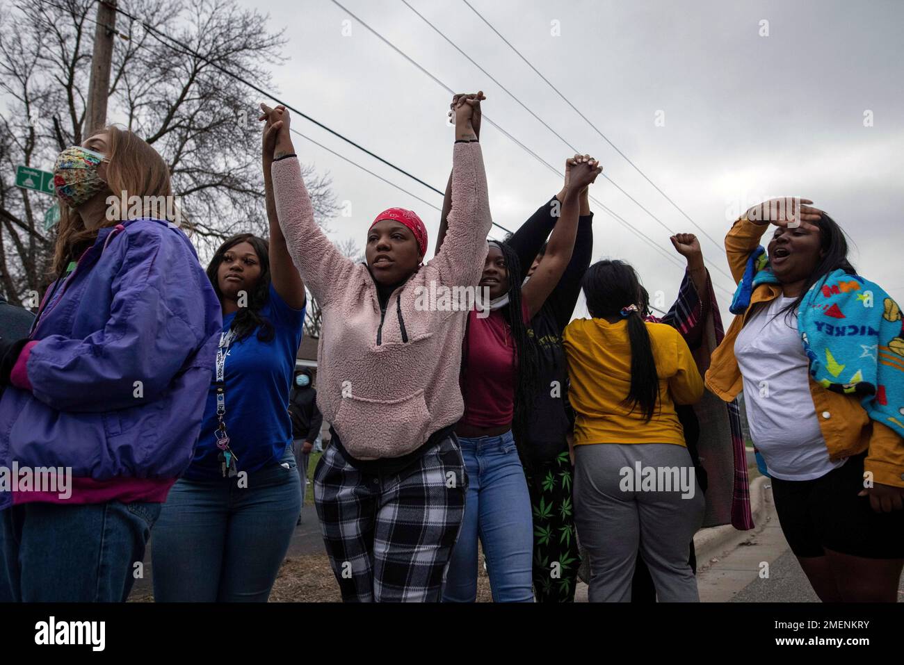 People raise their arms in protest, Sunday, April 11, 2021, in Brooklyn ...