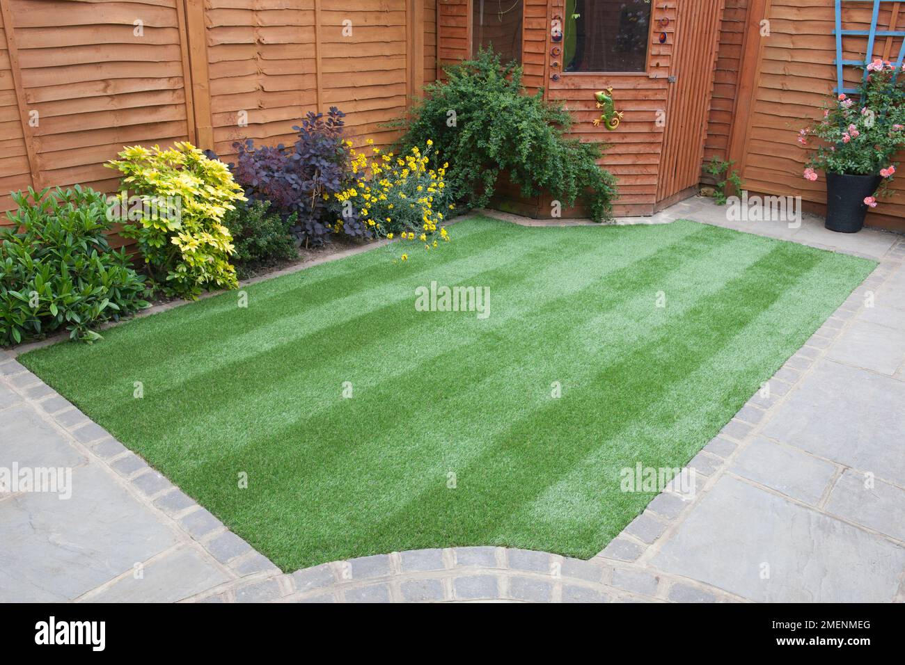 Small garden with artificial lawn space Stock Photo - Alamy