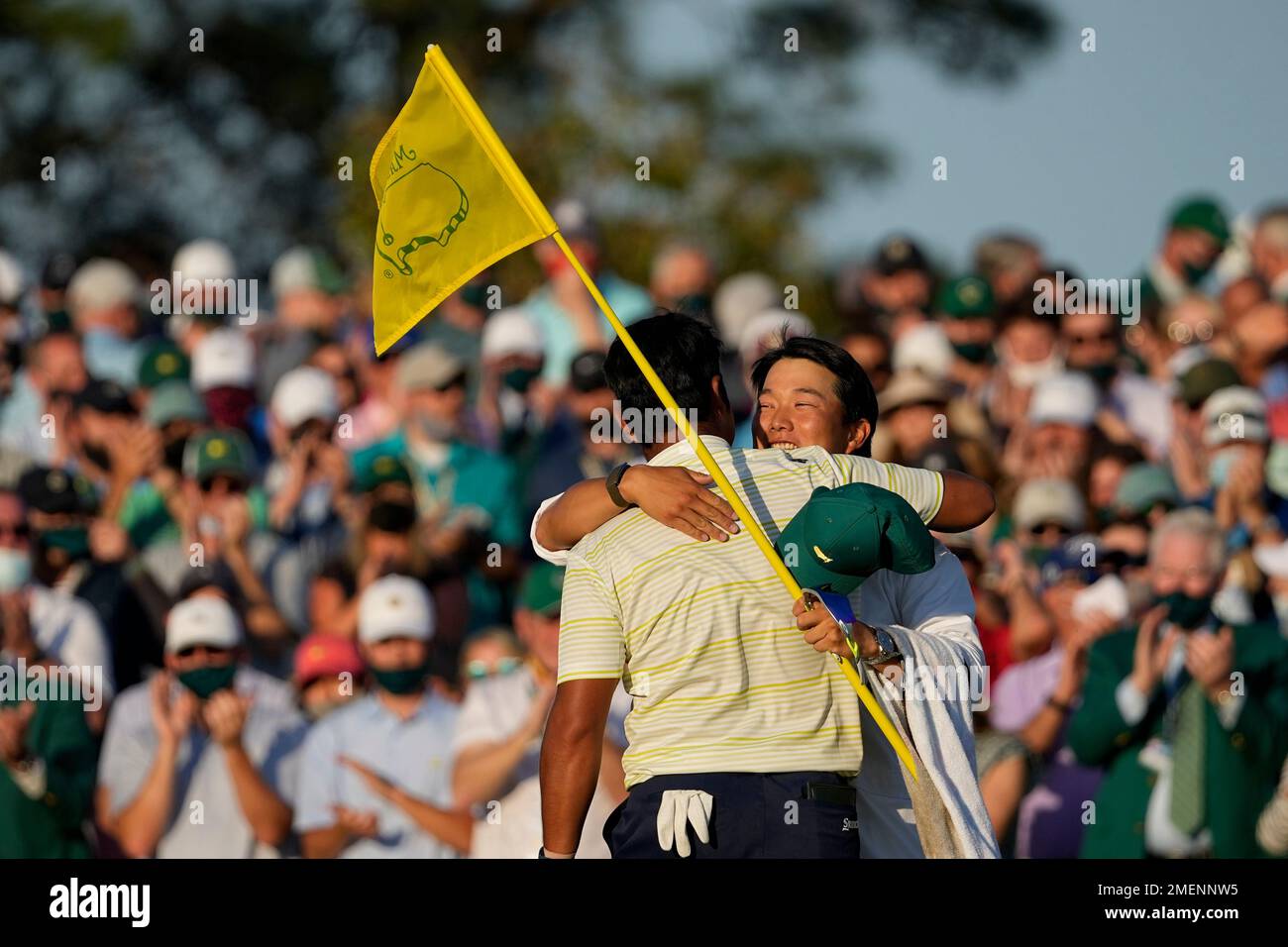 Hideki Matsuyama, of Japan, hugs his caddie Shota Hayafuji after ...