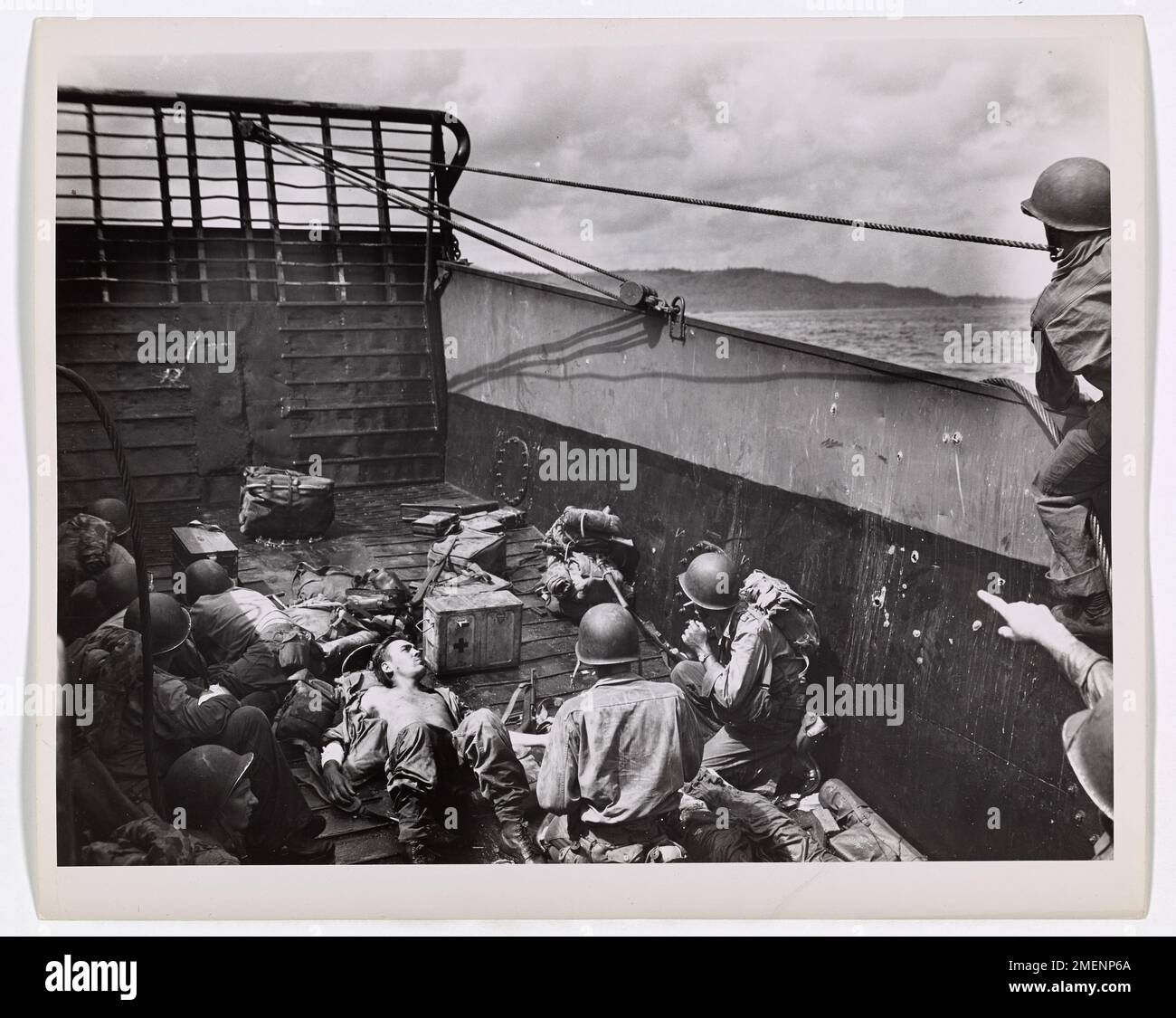A Coast Guard-manned landing barge transports wounded soldiers from the ...