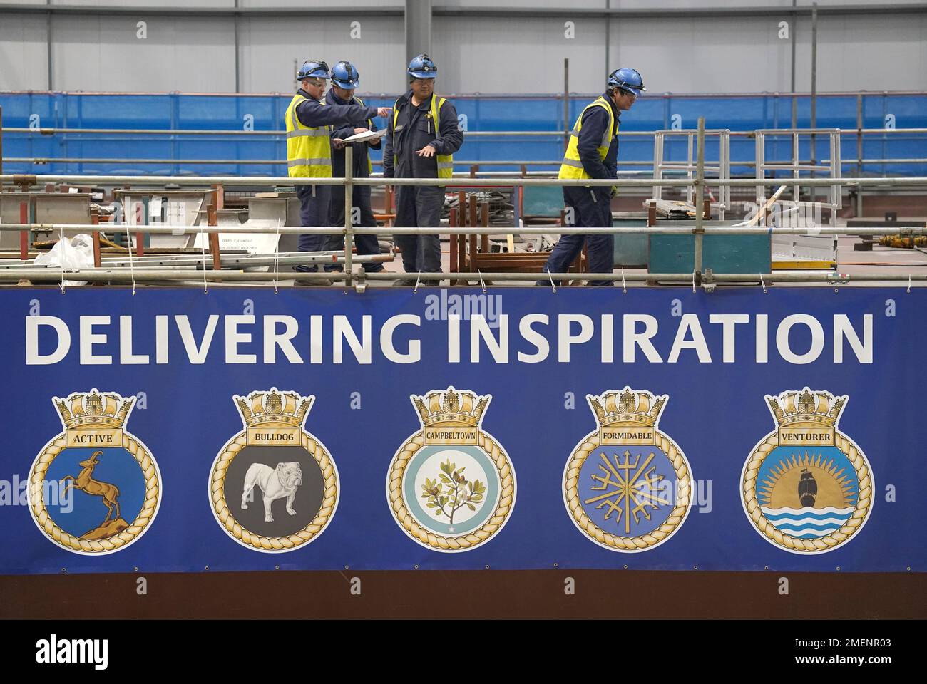 Workers work on HMS Ventura in the Ventura building after a ceremony ...