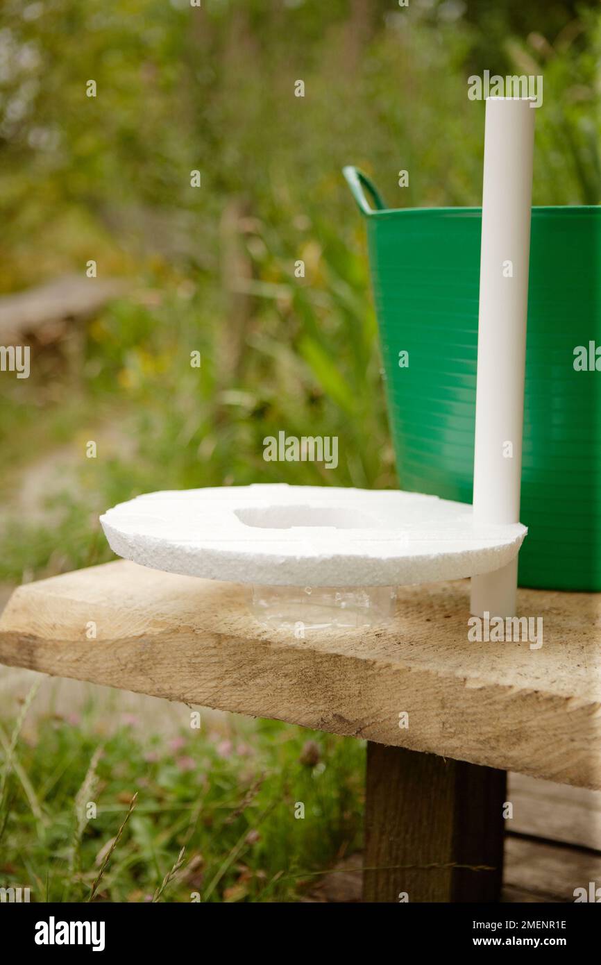 polystyrene disc and tube with plastic pot - infront of bucket Stock ...