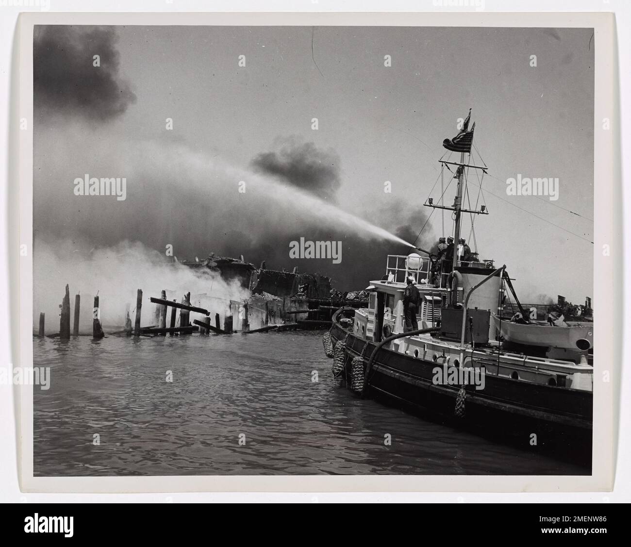 Coast Guard fireboats battle dock fires in the warehouse area. The ...