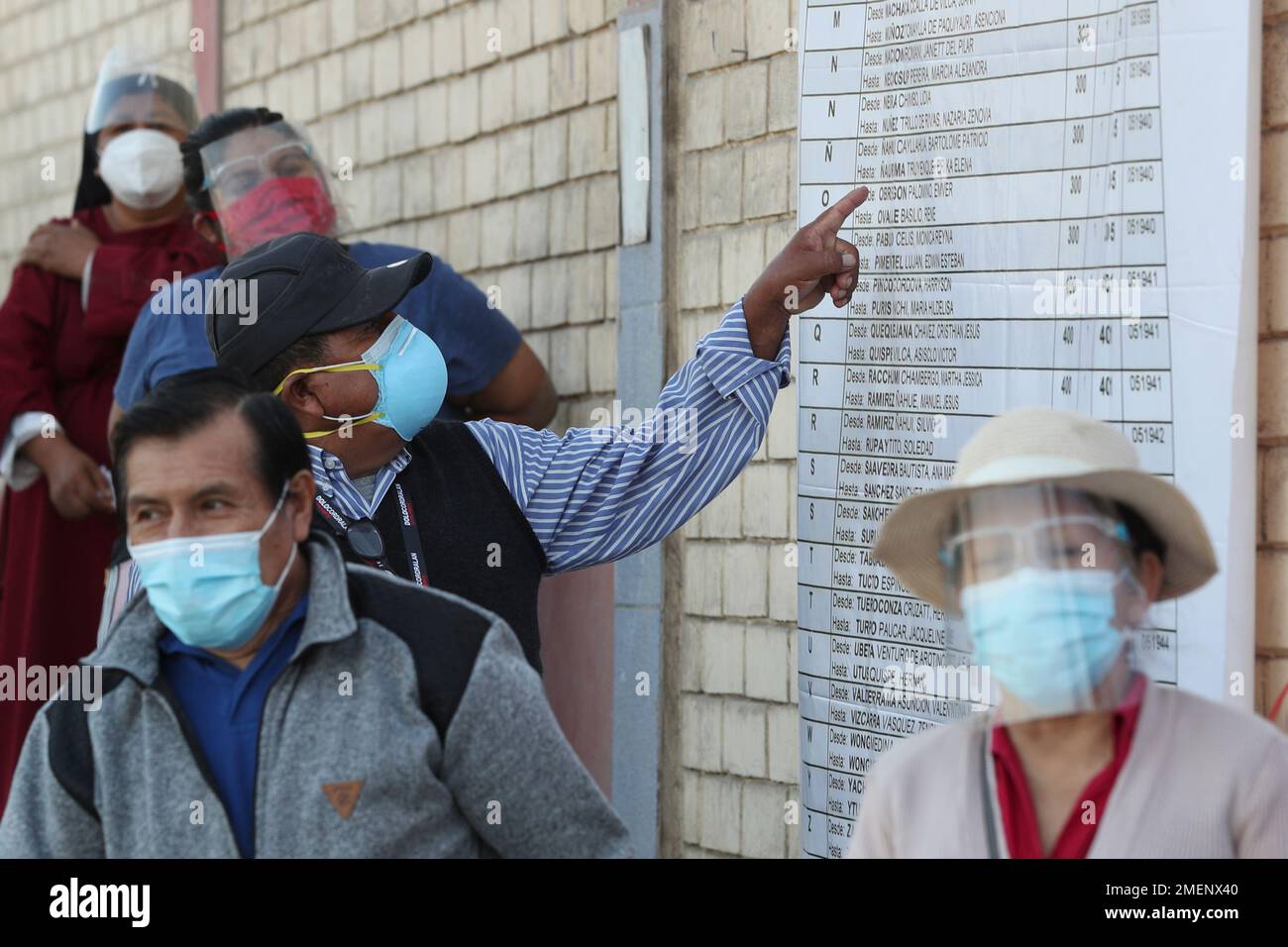 A voter checks his voting post during general elections in Lima, Peru ...