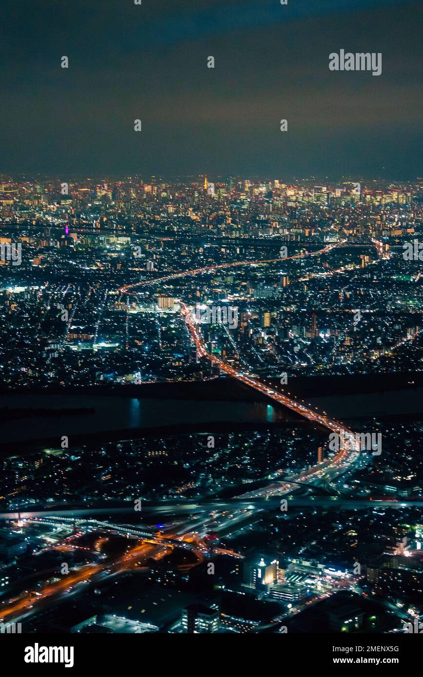 An aerial view of Tokyo cityscape illuminated with lights at night ...