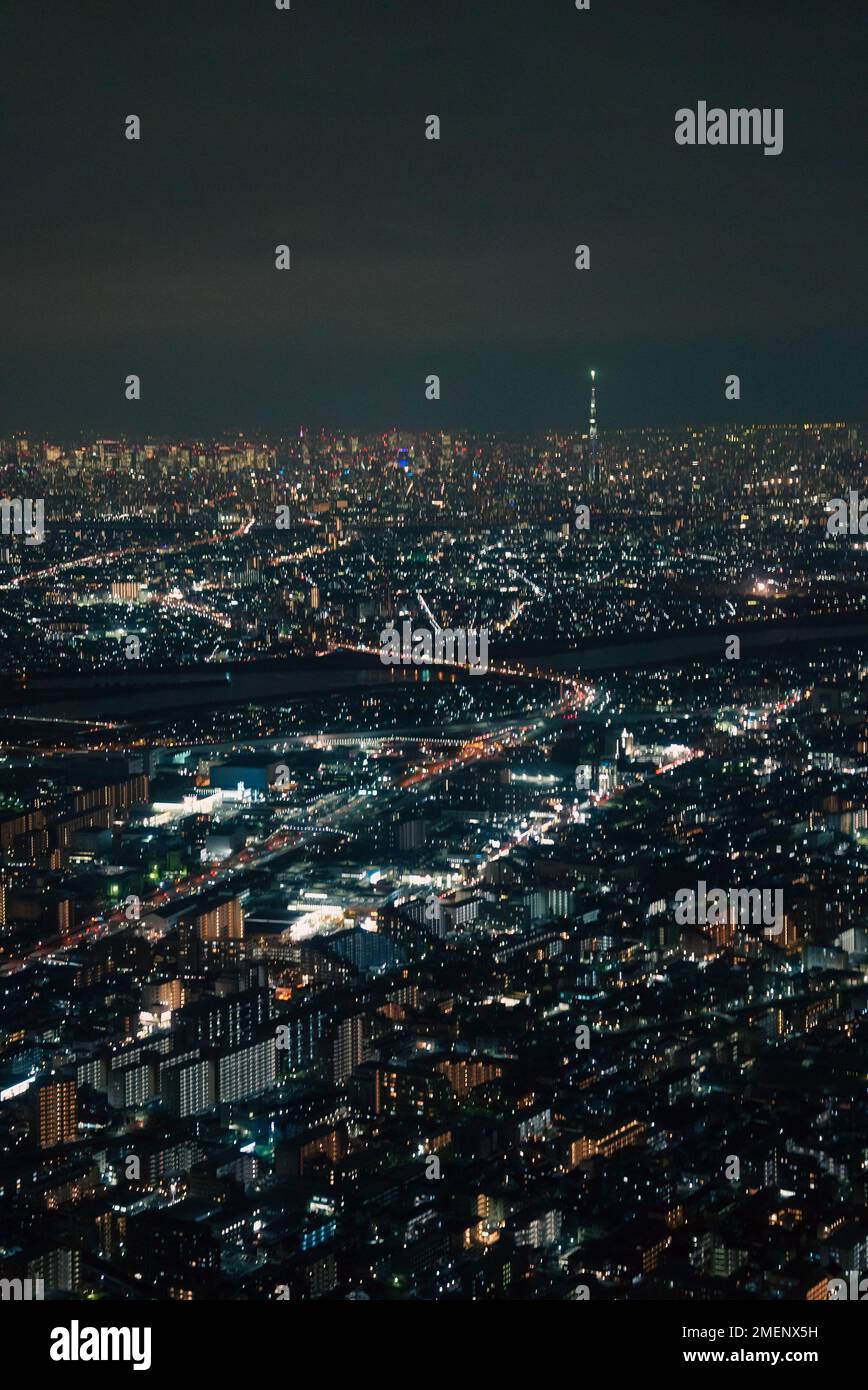 An aerial view of Tokyo cityscape illuminated with lights at night ...