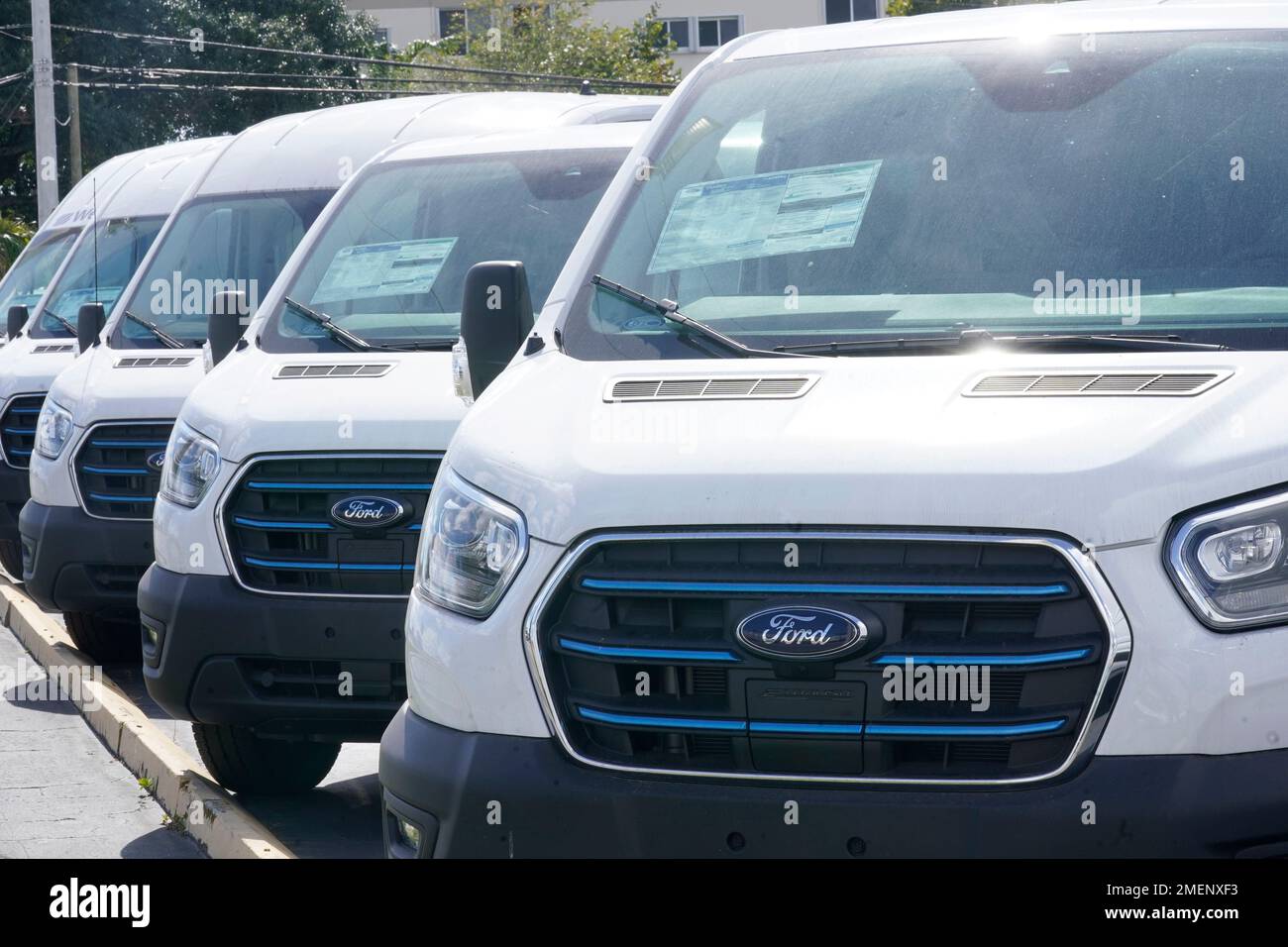 Ford E-Transit vans are for sale at a Gus Machado Ford dealership ...