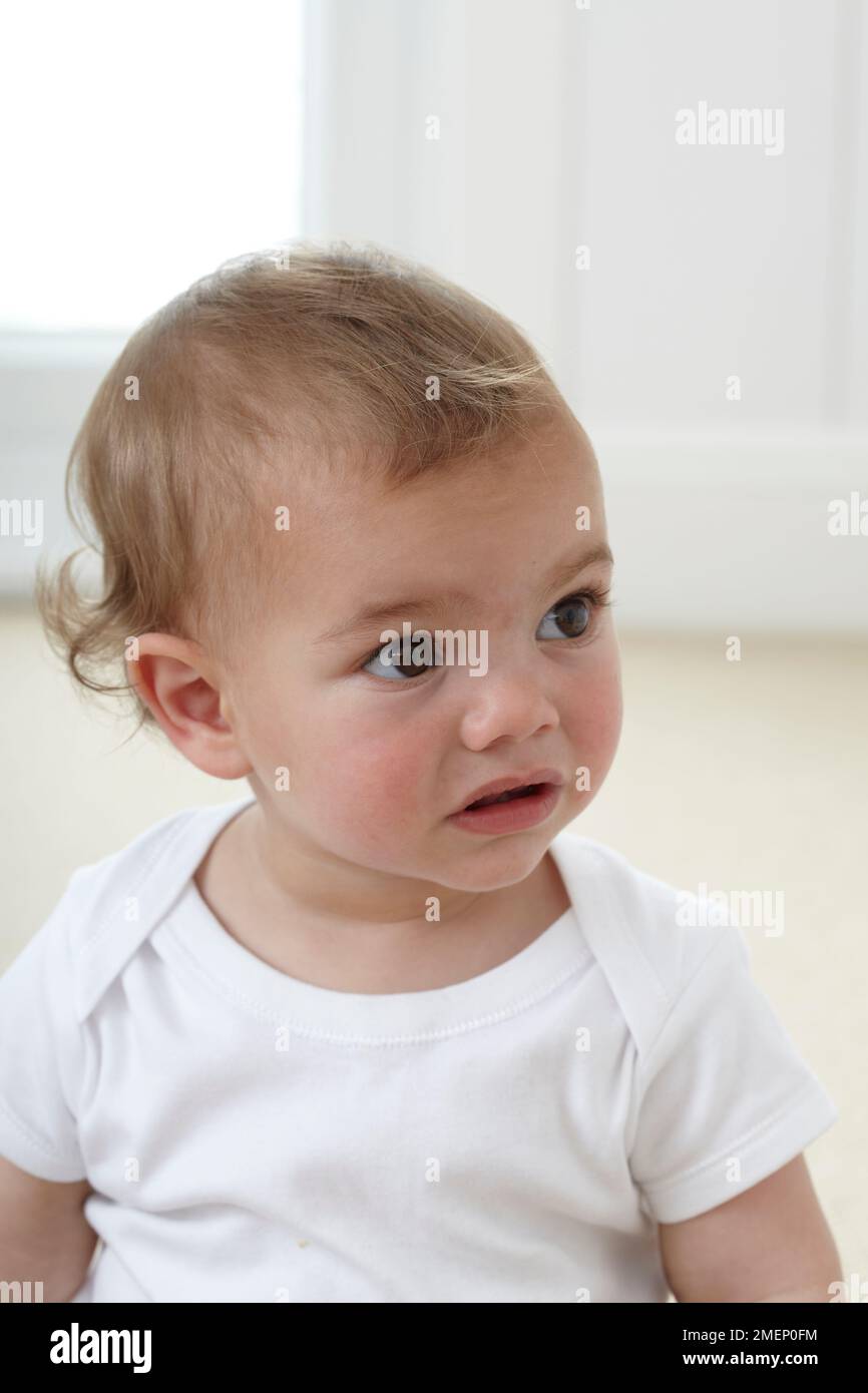 Tearful baby boy (46 weeks), front view Stock Photo - Alamy