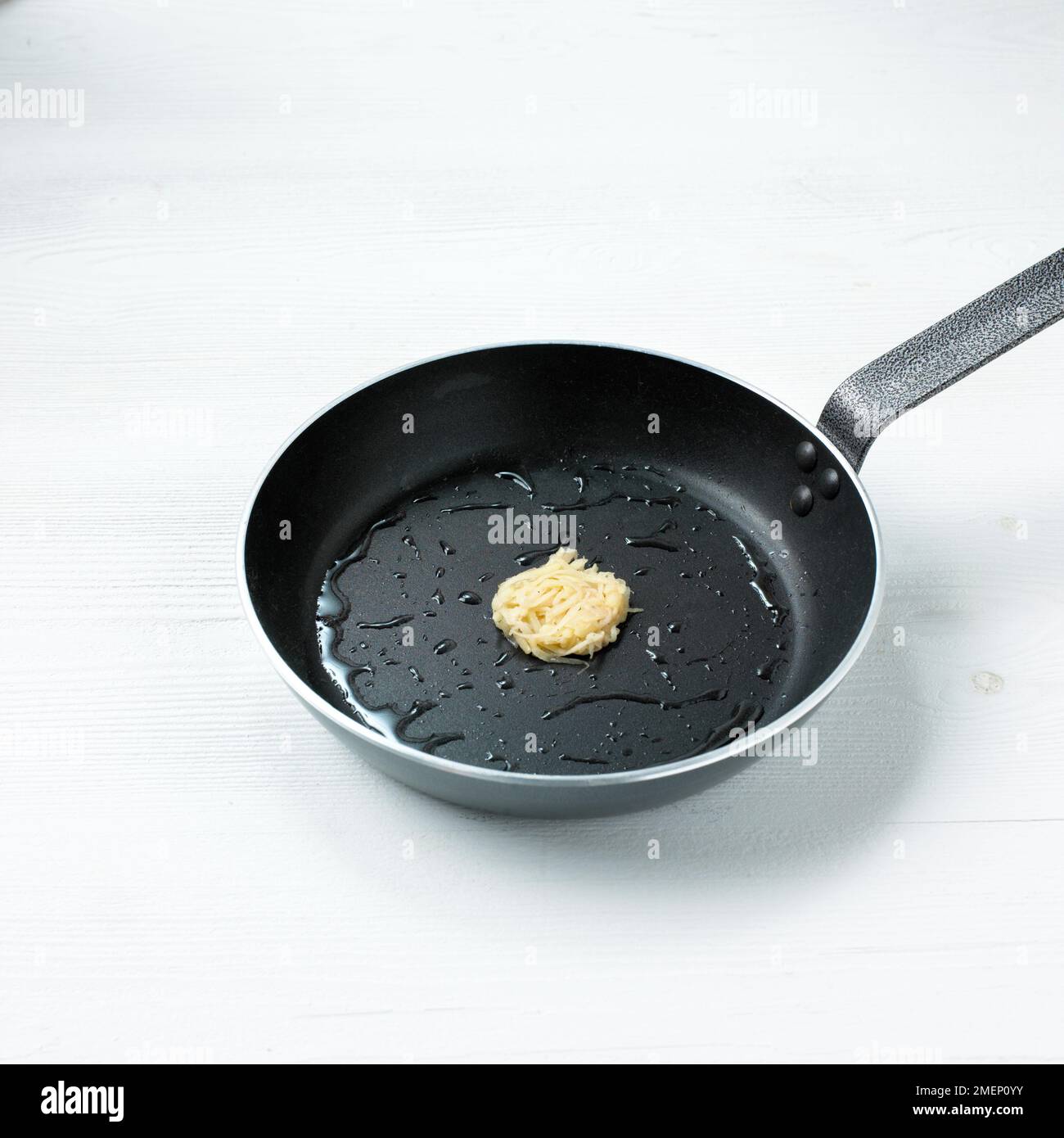 Mini rosti in frying pan Stock Photo - Alamy