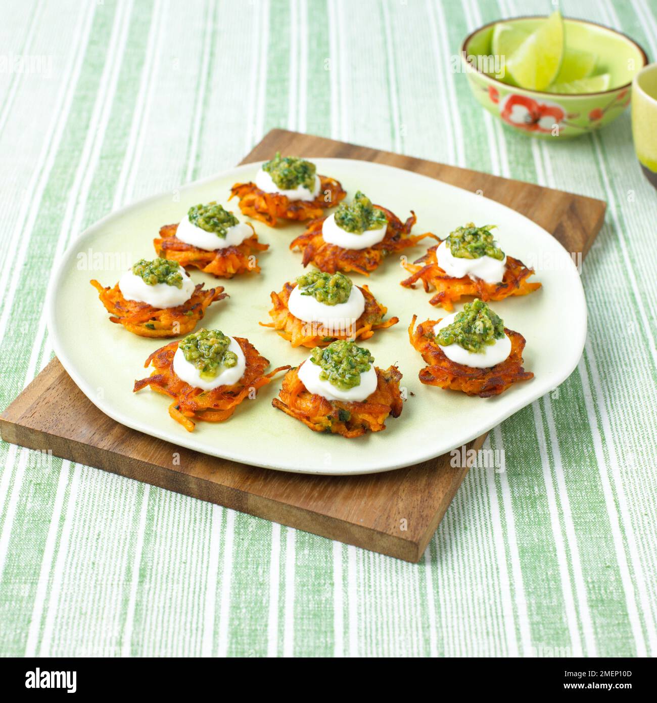 Mini rosti topped with cheese and pesto Stock Photo - Alamy