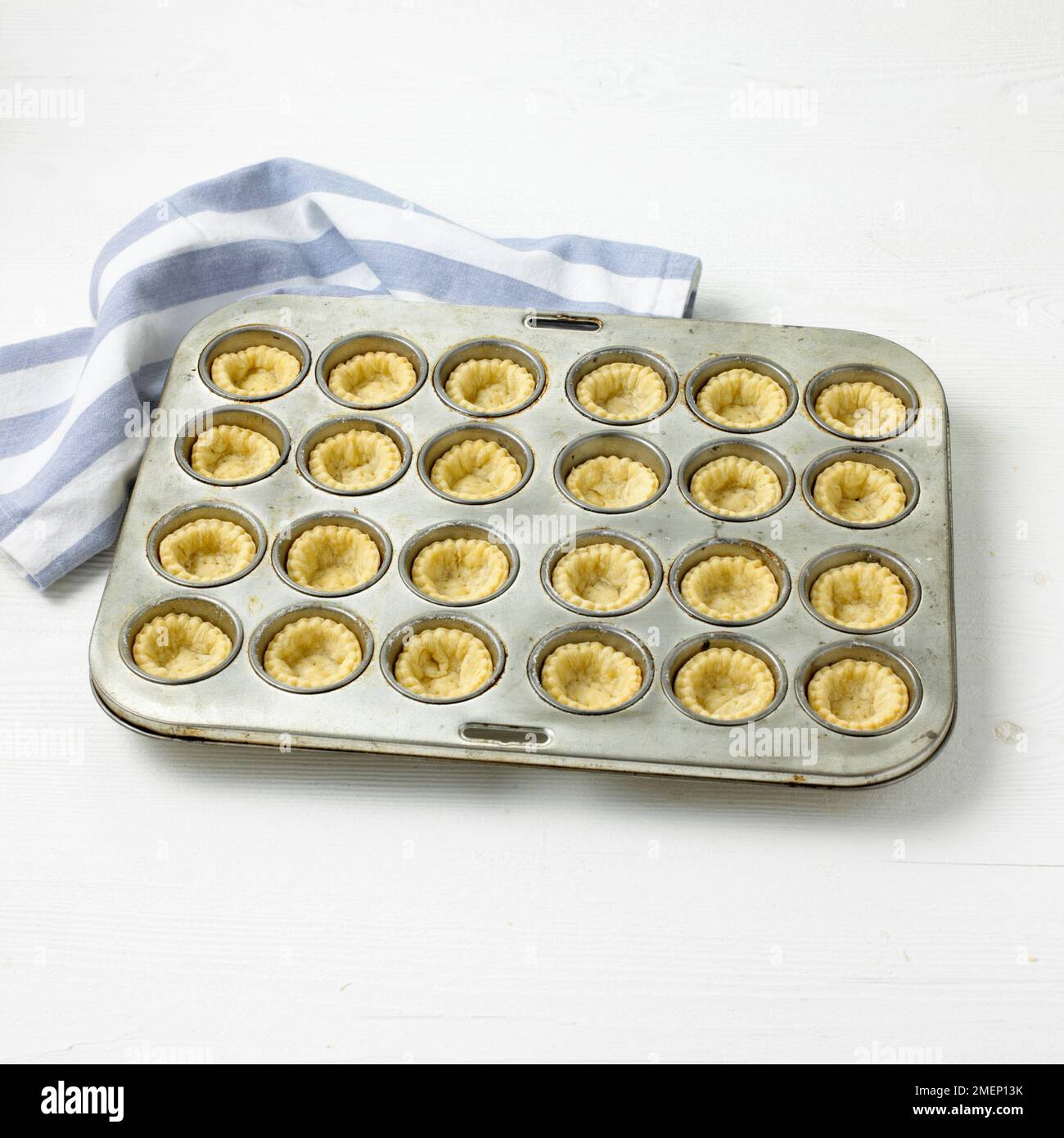 Baked shortcrust pastry tart shells in baking tray Stock Photo - Alamy