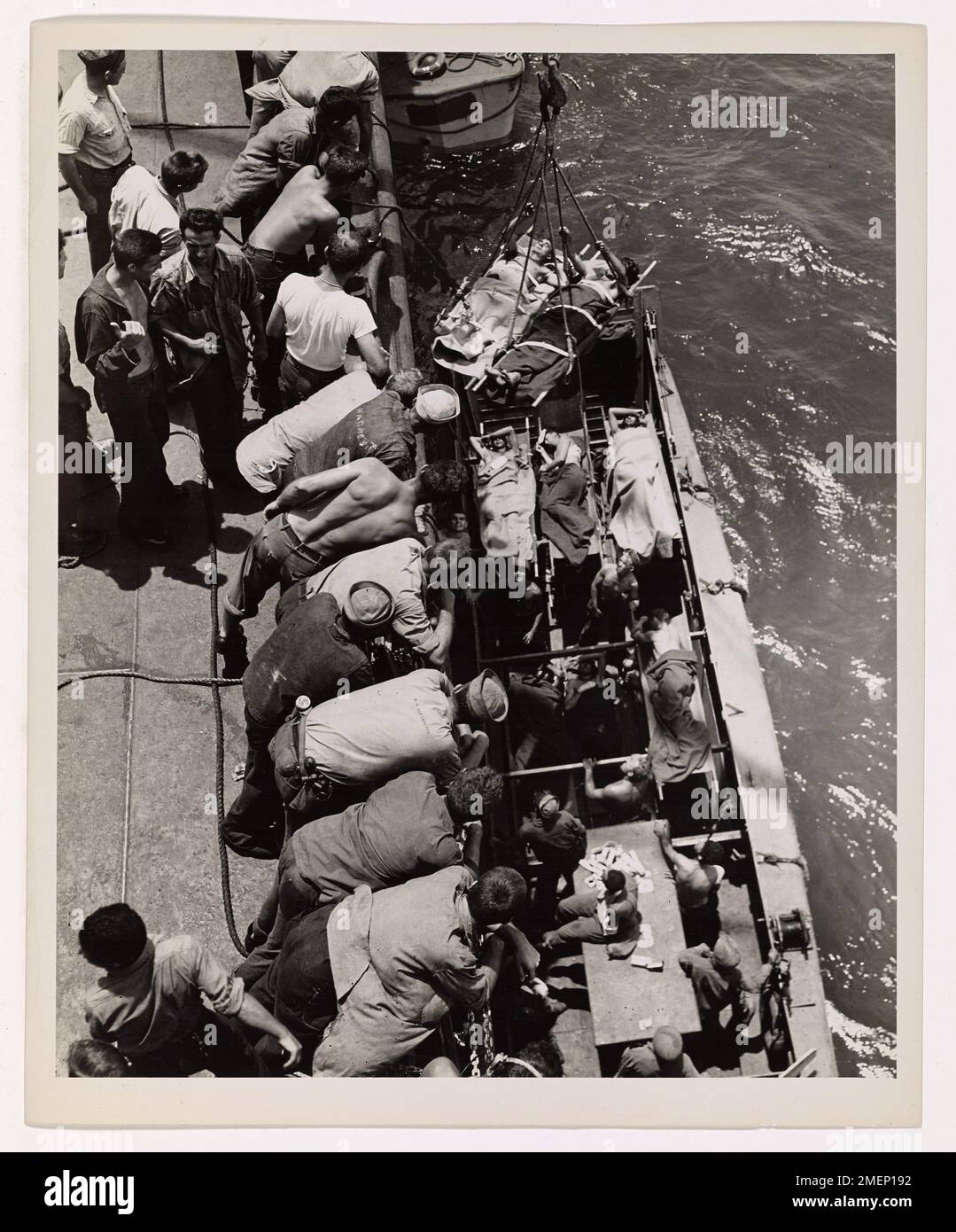 In this image, Coast Guard personnel aboard a converted landing barge ...