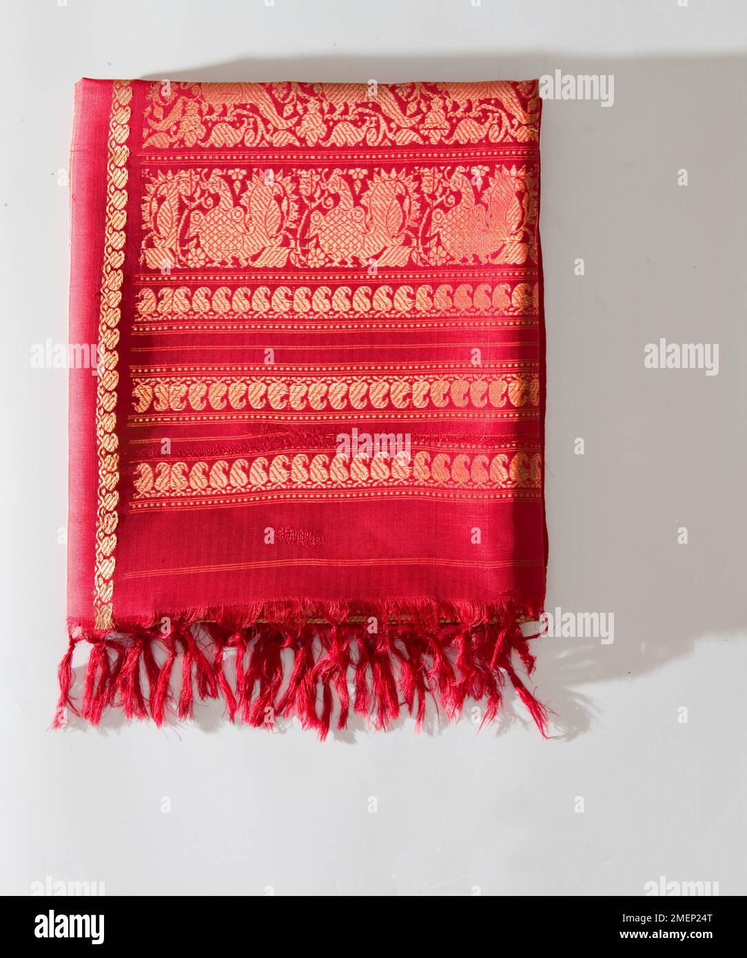 Red and gold Indian fabric with fringed edge Stock Photo - Alamy