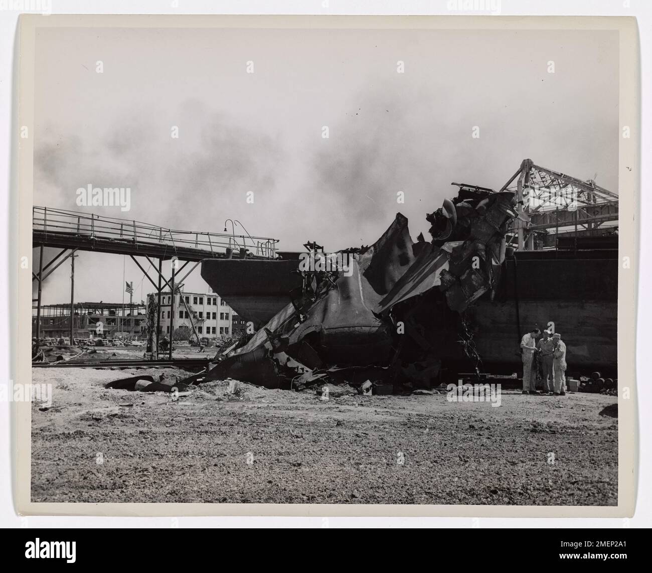 The twisted remains of a ship section lie on the inland side of the ...