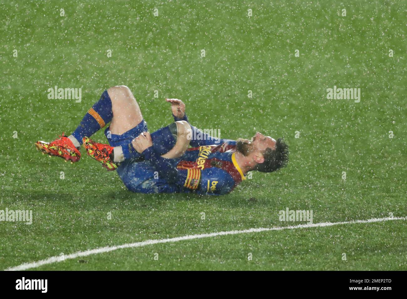 Barcelona's Lionel Messi gestures in pain after being tackled during ...